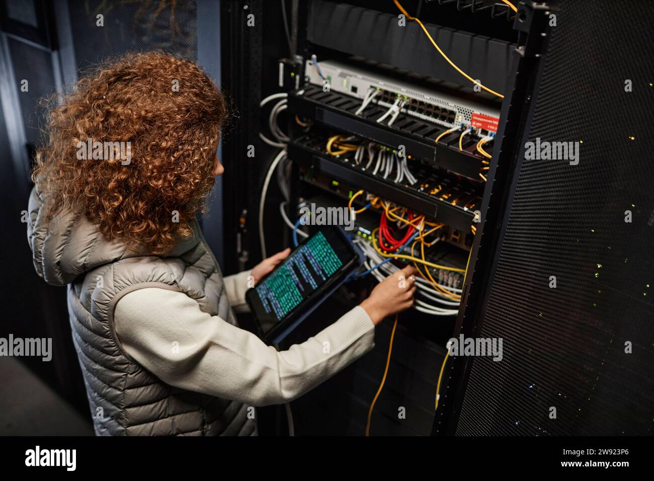 IT professional using tablet PC with data on screen and connecting ...