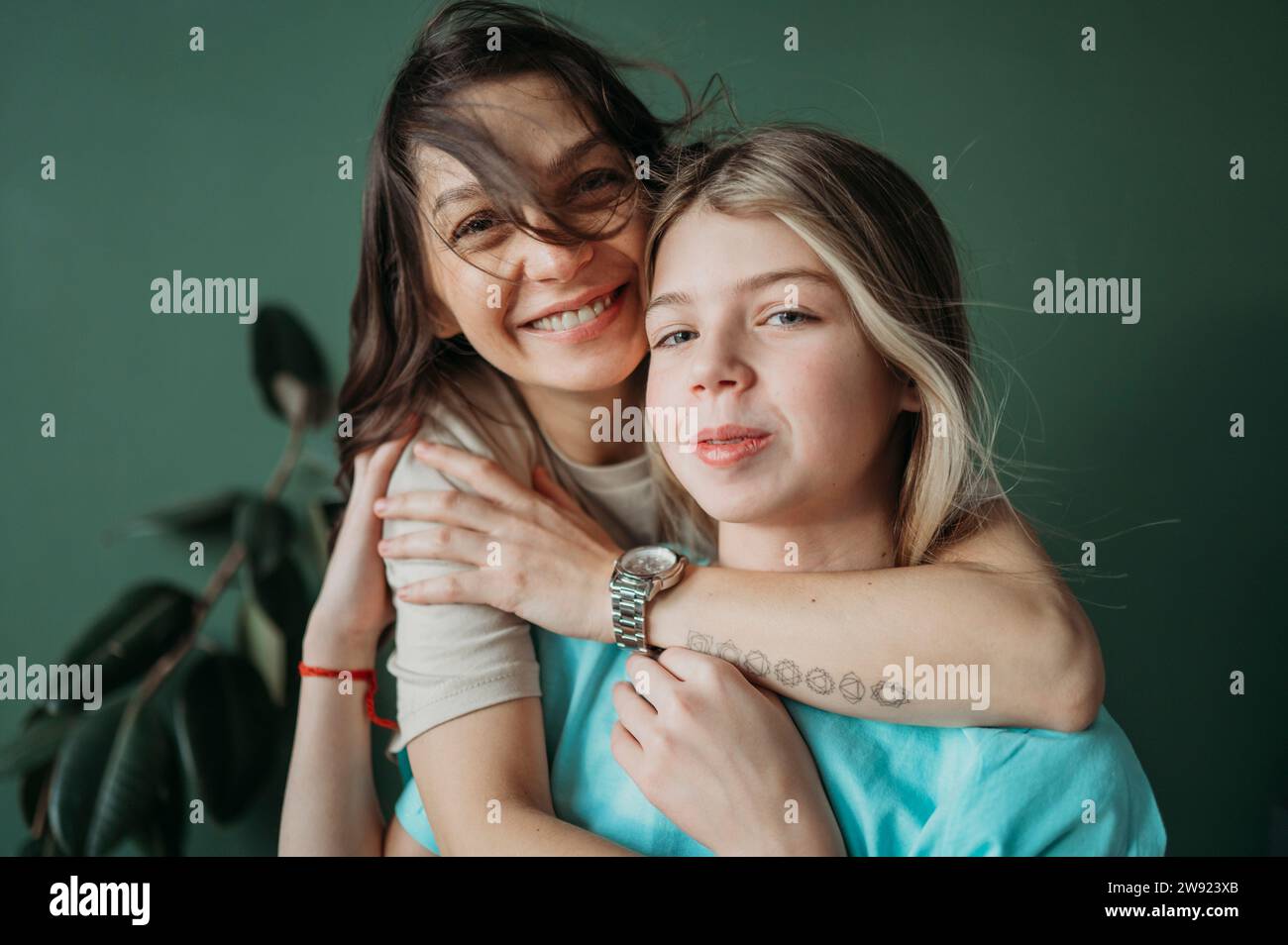 Happy mother hugging daughter at home Stock Photo - Alamy