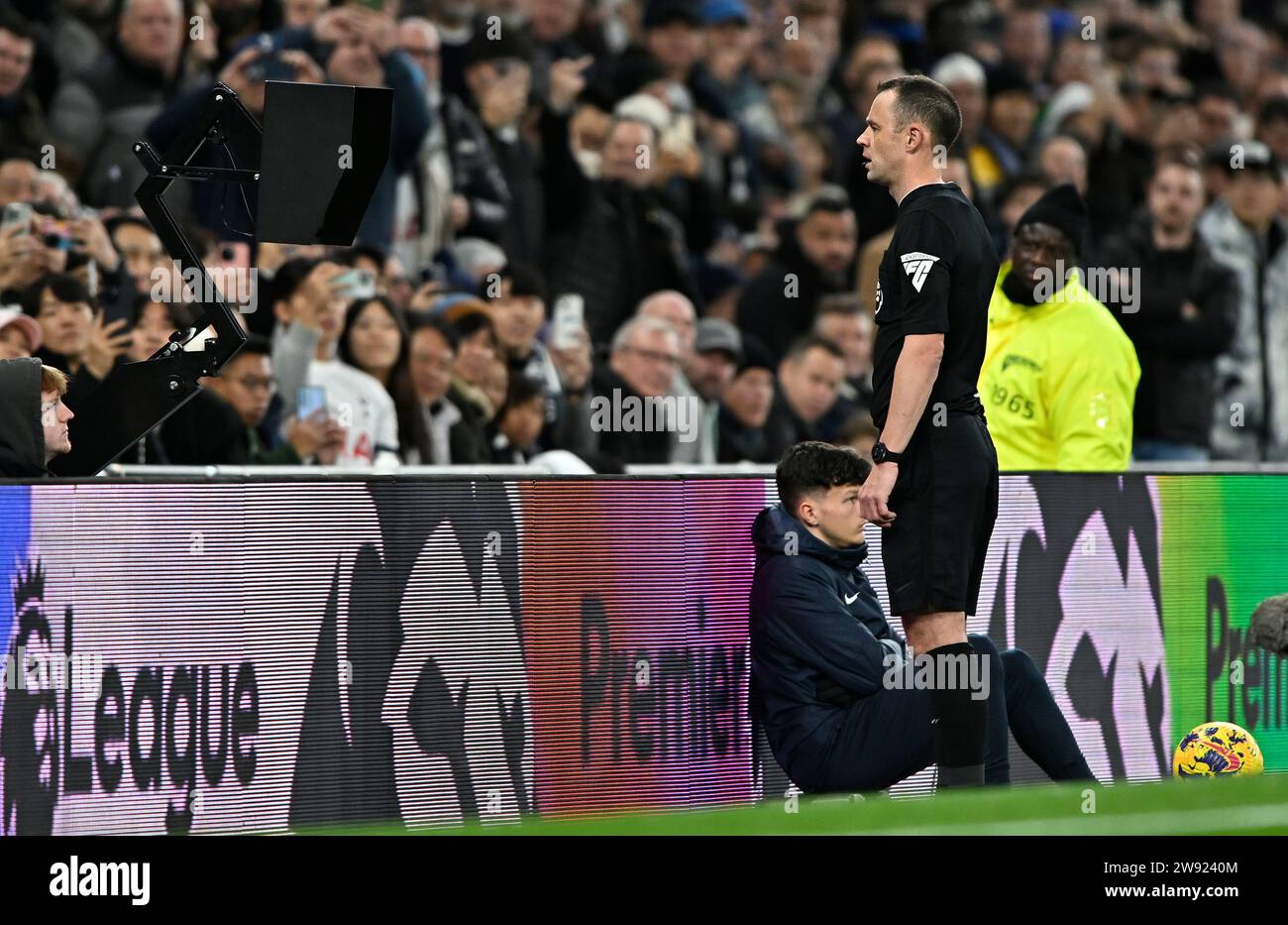 London, UK. 23rd Dec, 2023. Stuart Attwell (Referee) looks at the VAR ...