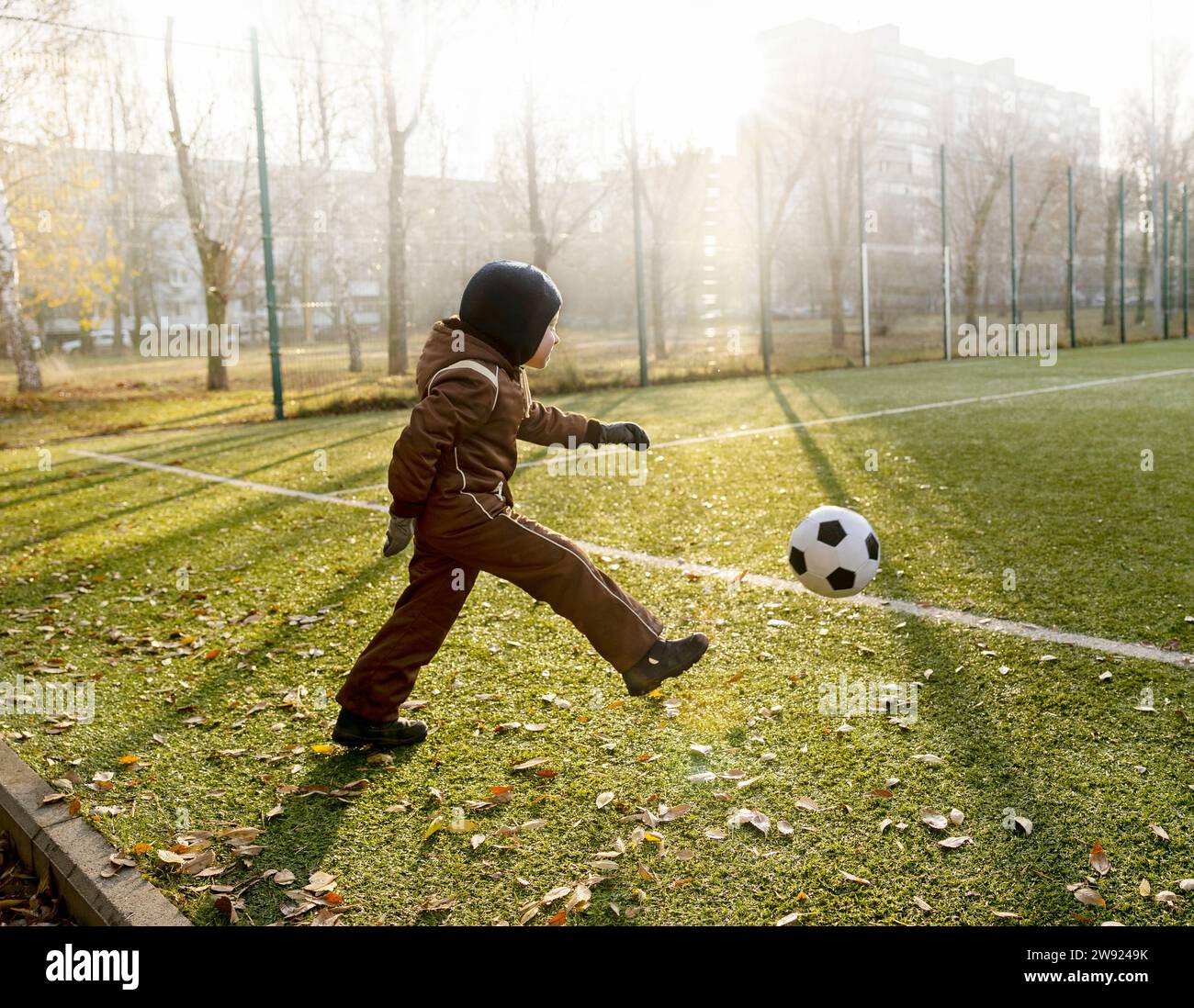 Children kicking ball hi-res stock photography and images - Alamy