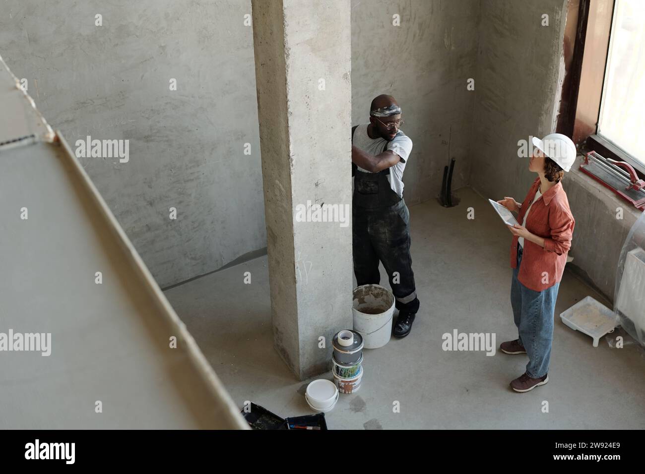 Engineer discussing over architectural column with coworker at ...