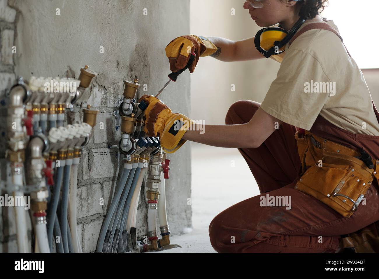 Electrician working with screwdriver at construction site Stock Photo ...