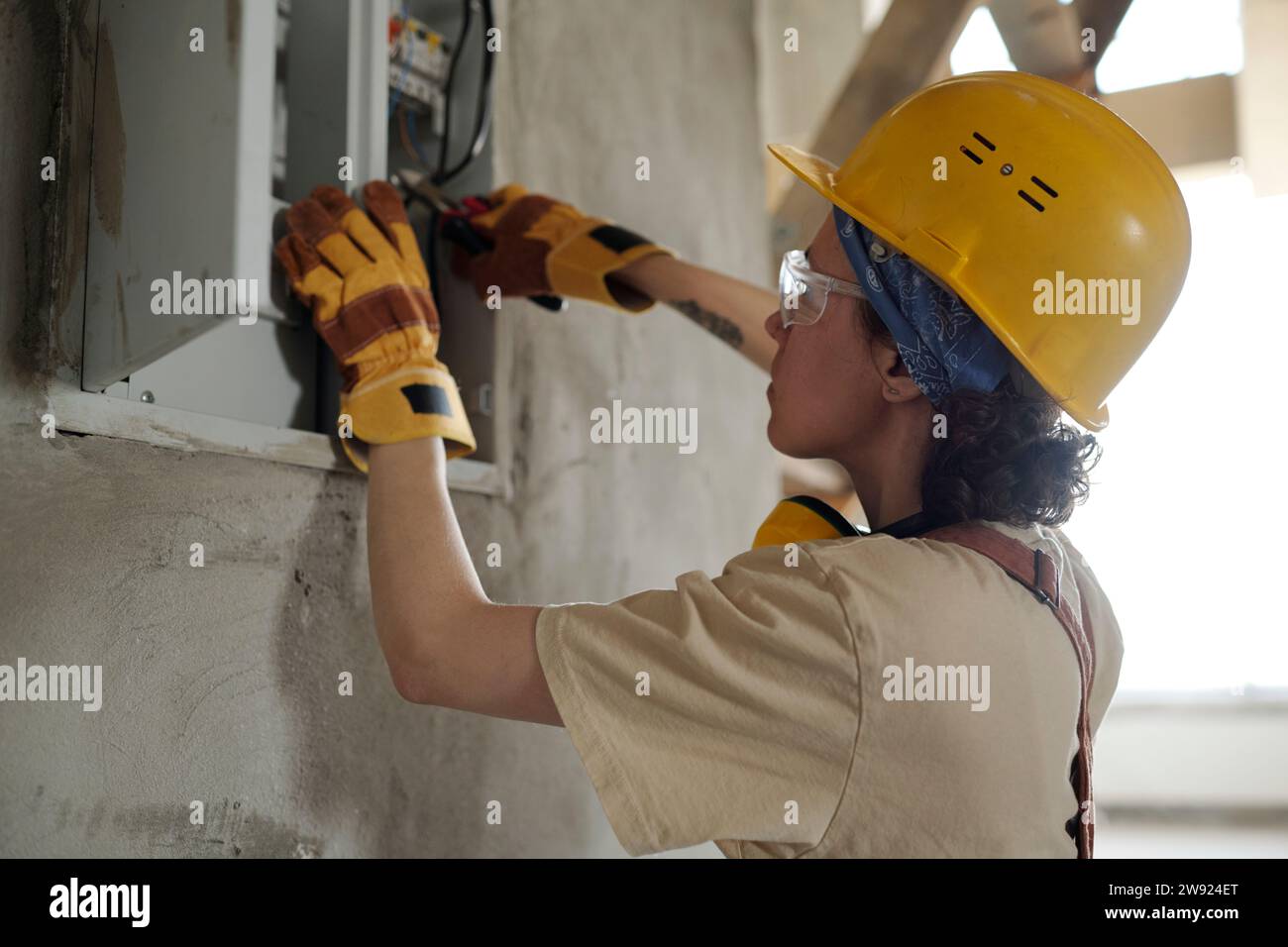 Electrician working on electric meter at construction site Stock Photo ...
