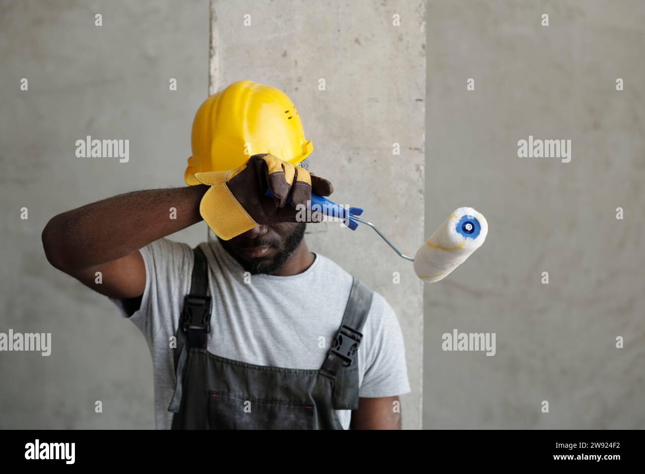 Tired construction worker wiping sweat at site Stock Photo - Alamy