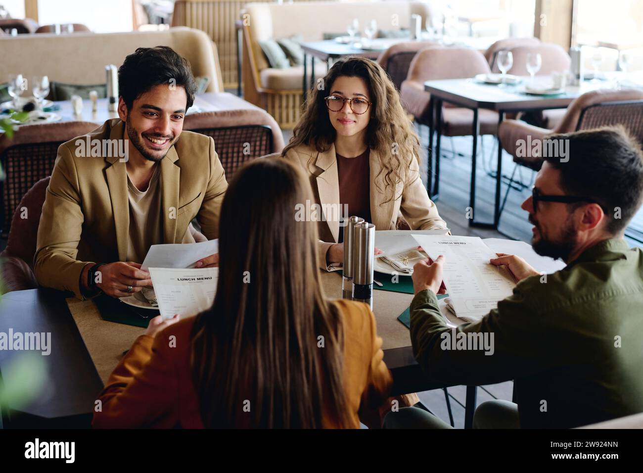 Happy colleagues having lunch break at restaurant Stock Photo - Alamy