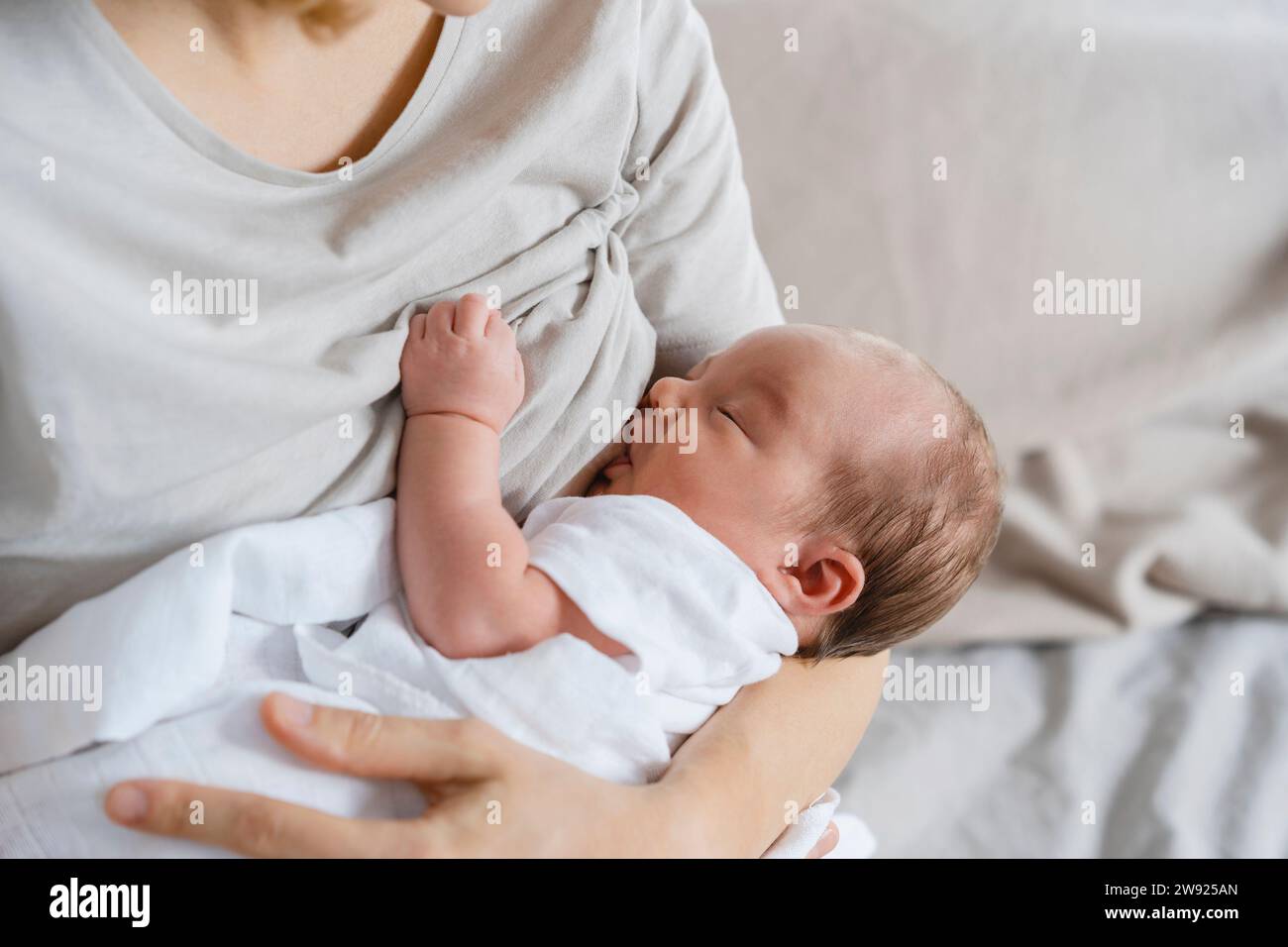 Mother breastfeeding baby boy in arms Stock Photo - Alamy