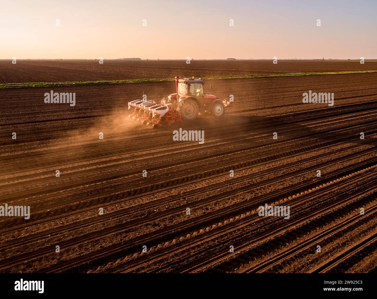 Serbia, Vojvodina Province, Aerial view of tractor sowing seeds in ...