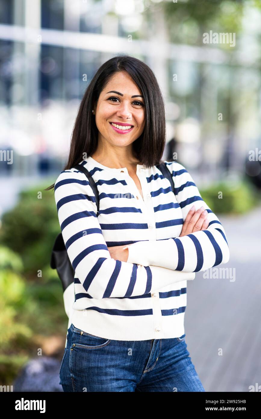 Happy woman crossed arms hi-res stock photography and images - Alamy
