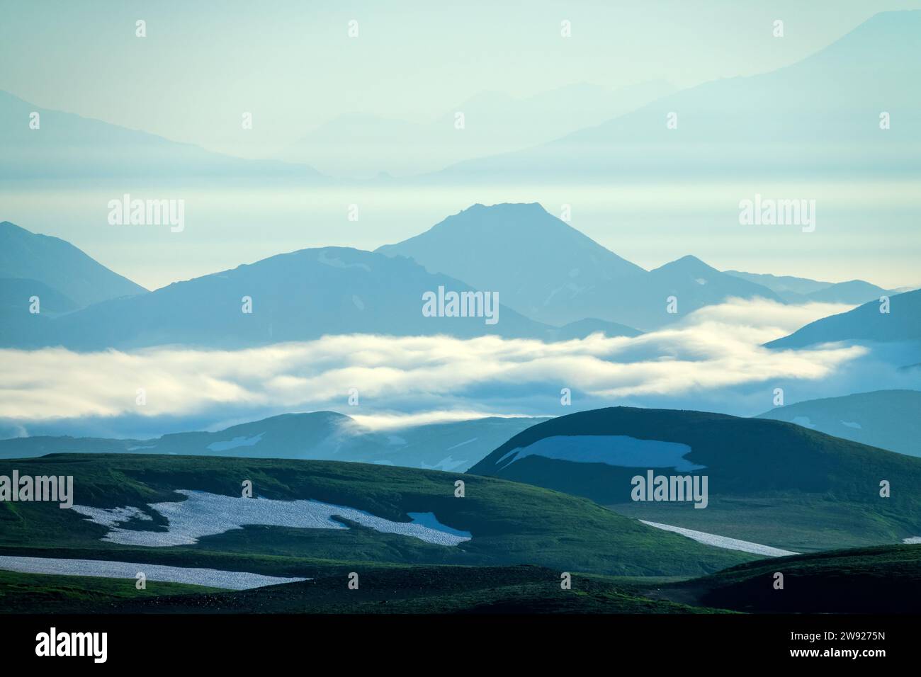 The clouds roll into the valley. Panorama of volcanogenic mountains ...