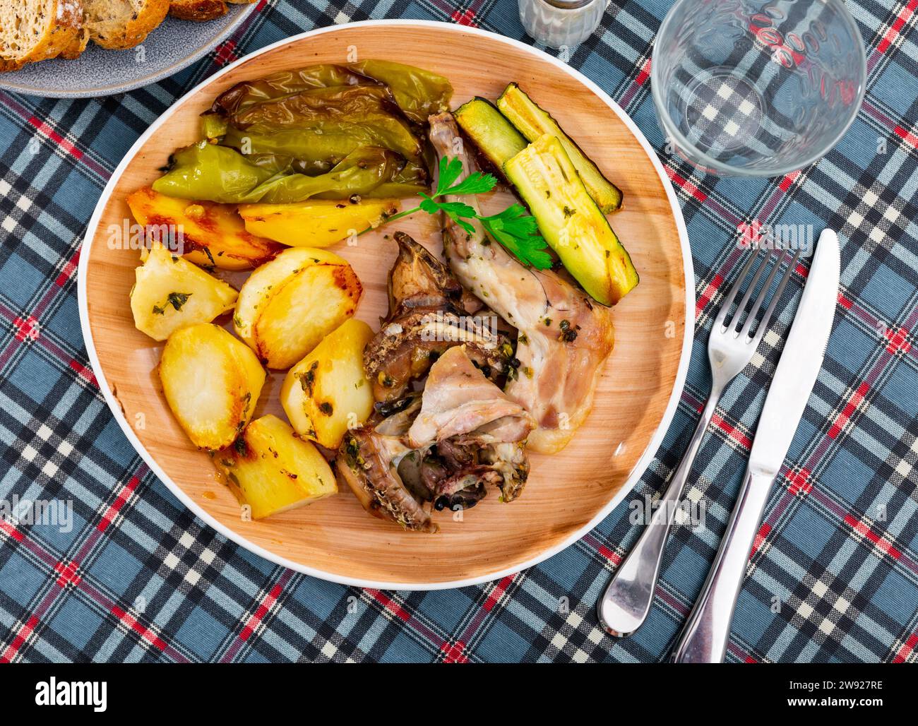 Roasted rabbit served with vegetable garnish Stock Photo - Alamy