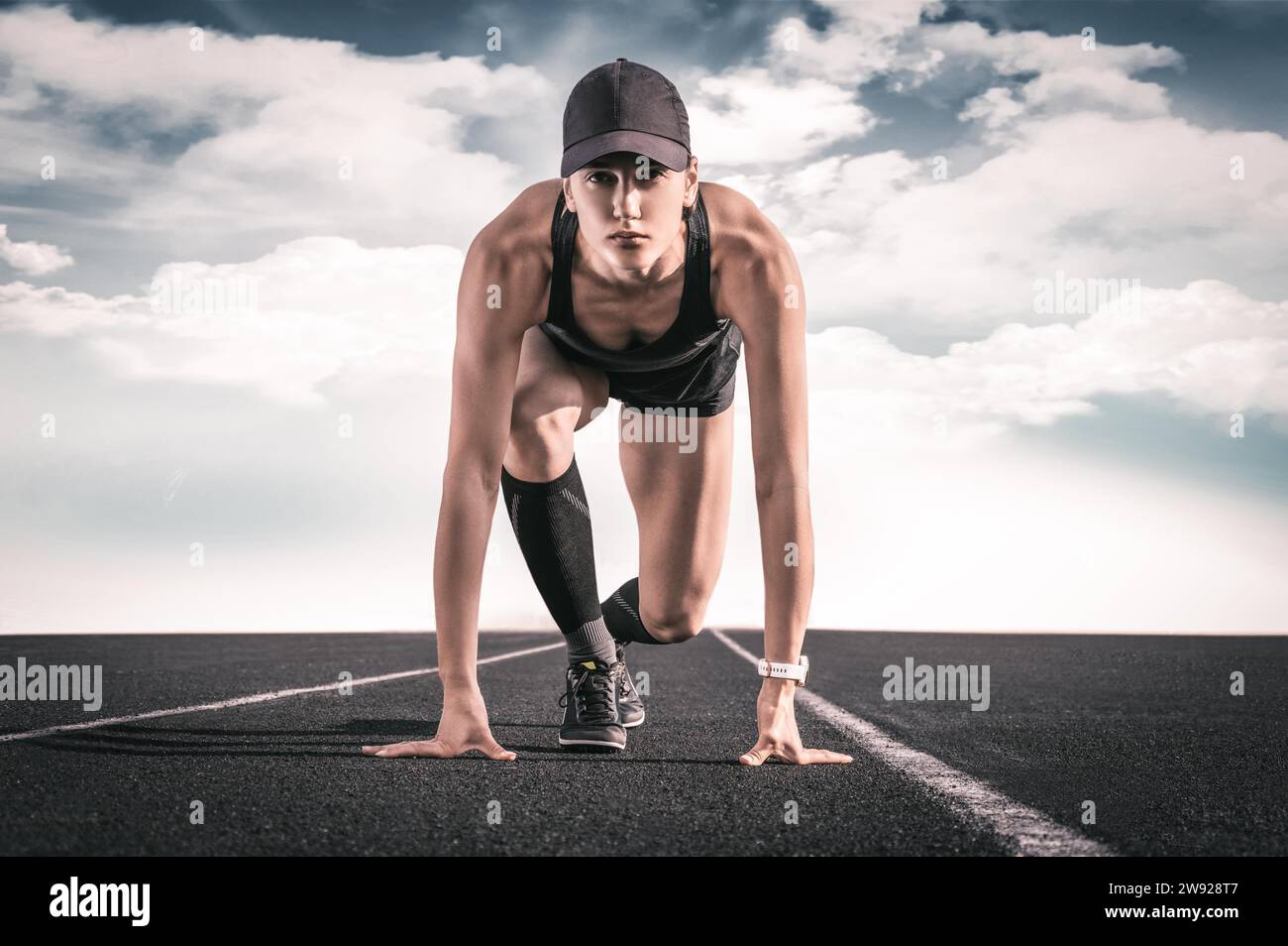 Image of a girl standing on the start line of the track. Running ...