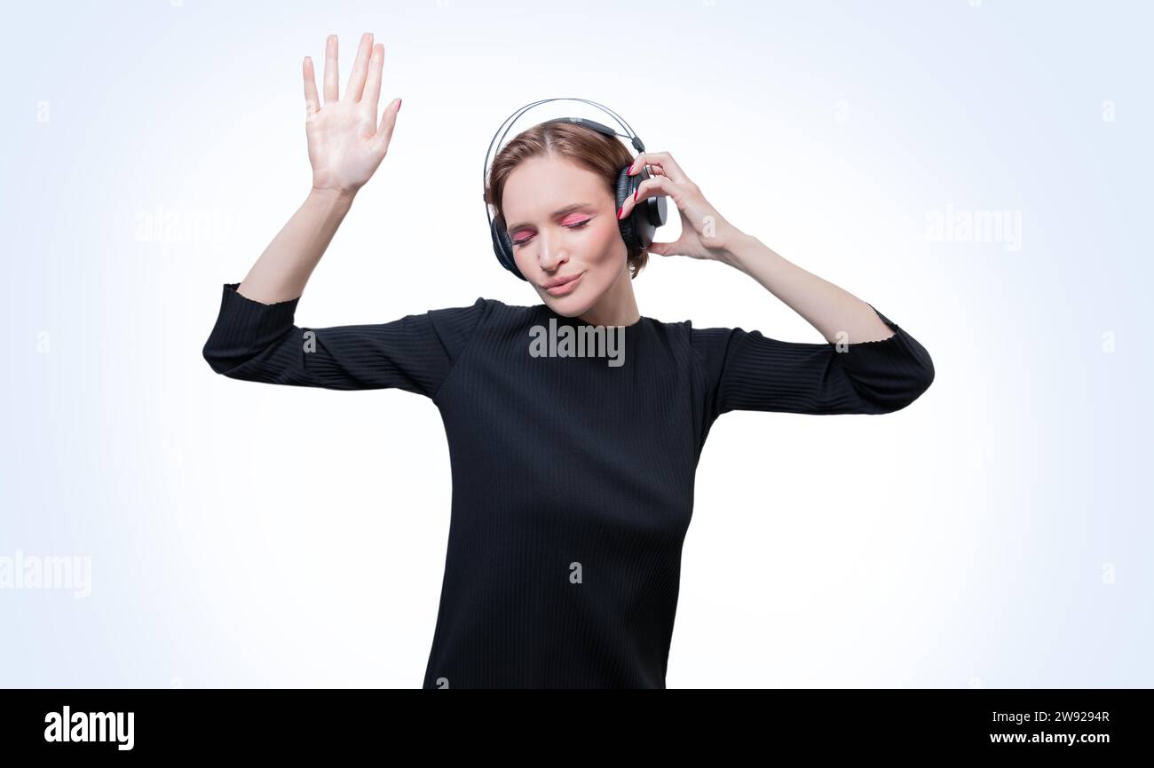 Portrait of a woman in professional headphones. White background. Dj ...