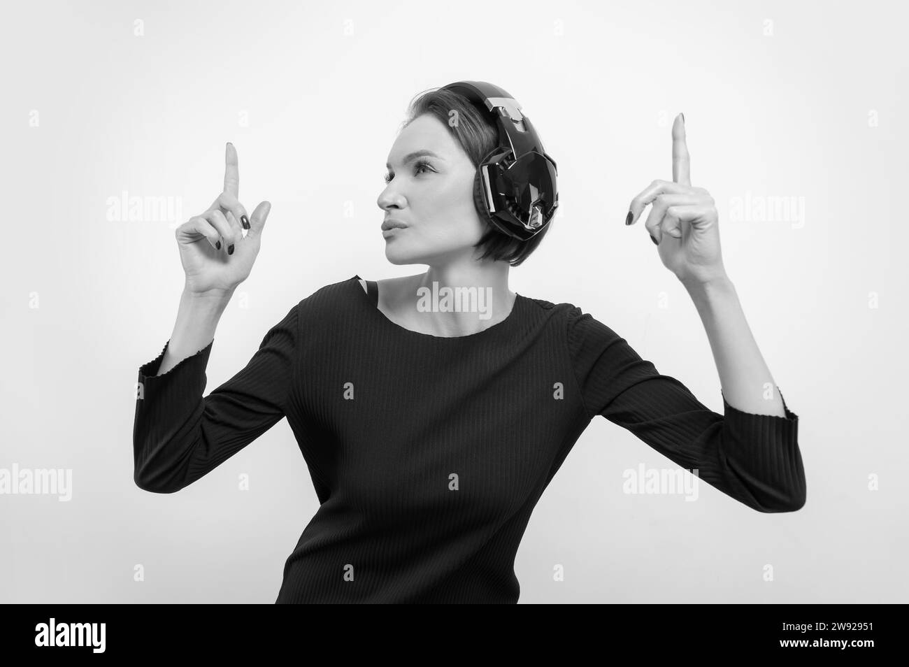 Portrait of a woman in professional headphones. White background. Dj ...