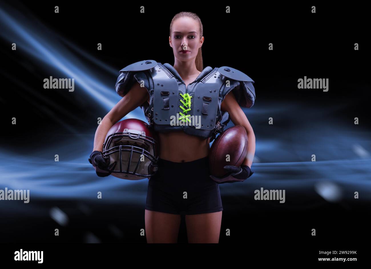 Portrait of a sportive girl in the uniform of an American football team ...