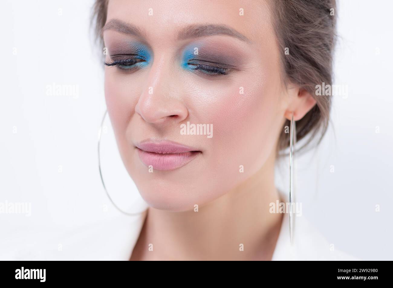 Portrait of a beautiful girl with a defiant make-up. White background ...