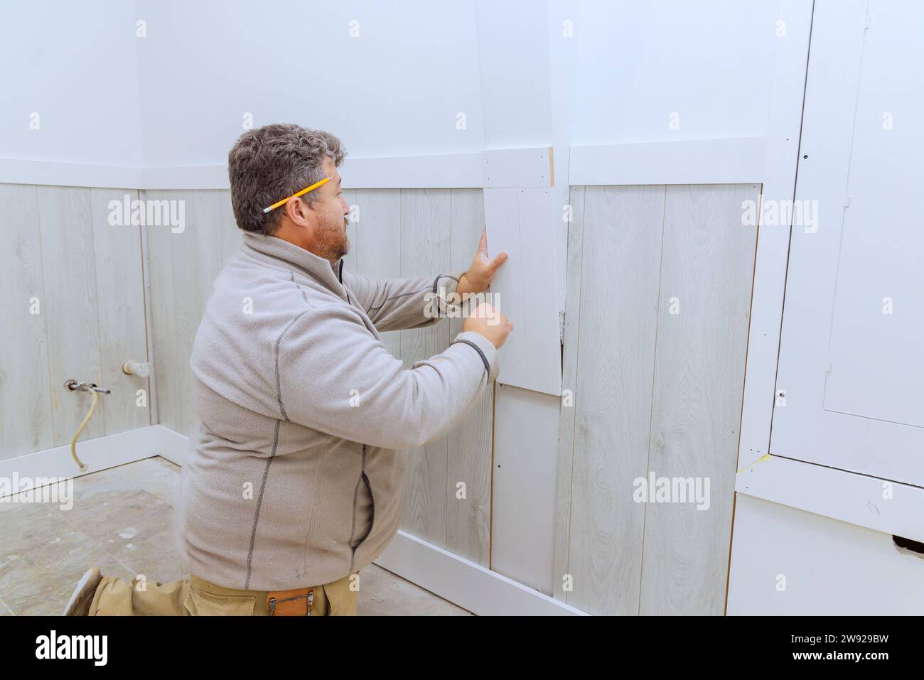 During installation of wooden trim moldings in room contractor nails ...