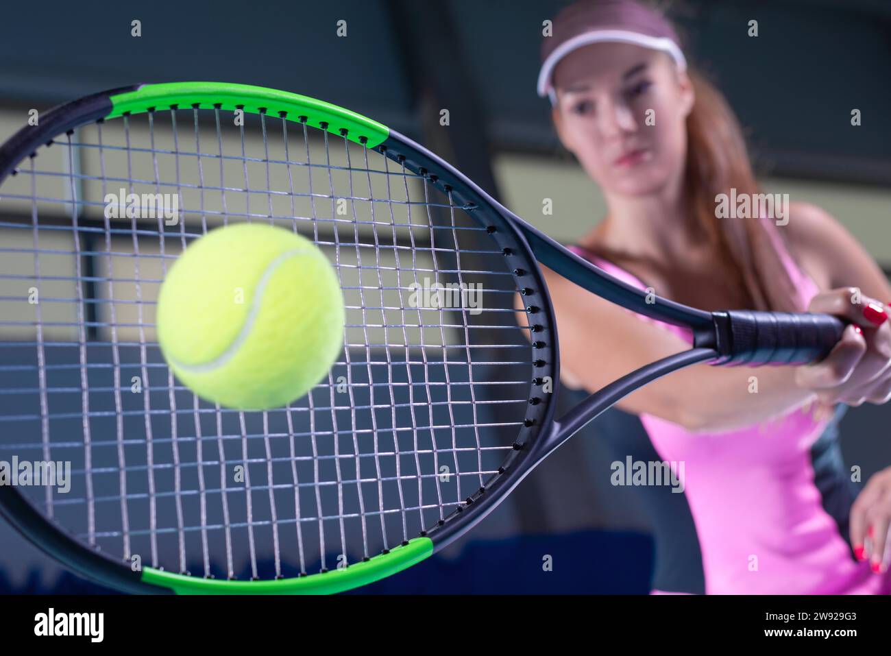 Image of a tennis ball on the background of the strings of the racket ...