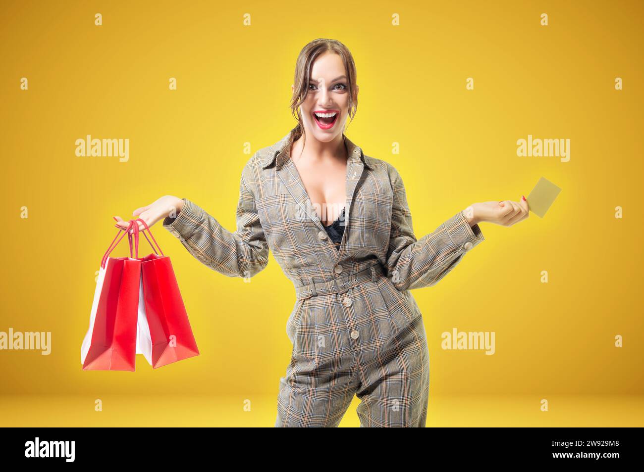 Beautiful tall woman with red packages in her hands. Pre-holiday ...