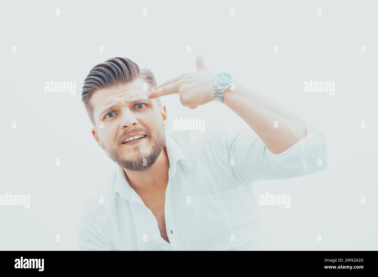 Stylish man imitates a gun shooting in the head. The concept of ...