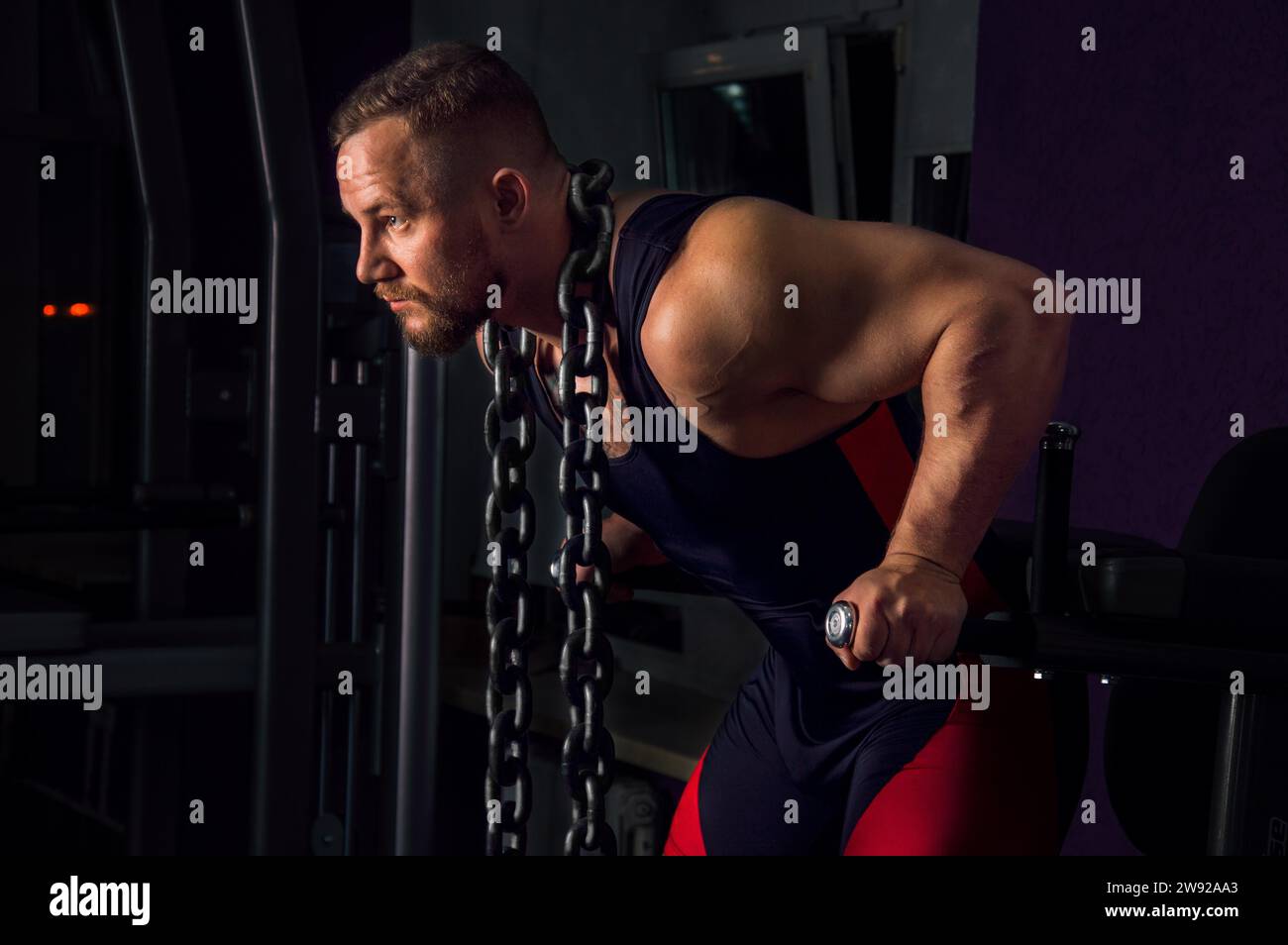 Weightlifter with a huge metal chain around his neck. Push-ups on the ...