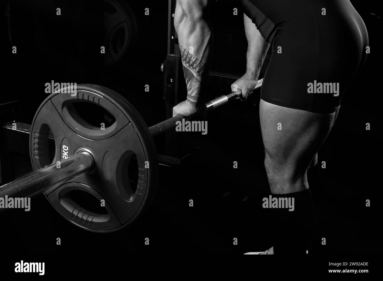 The athlete approaches the barbell and takes hold of it. Bottom view ...