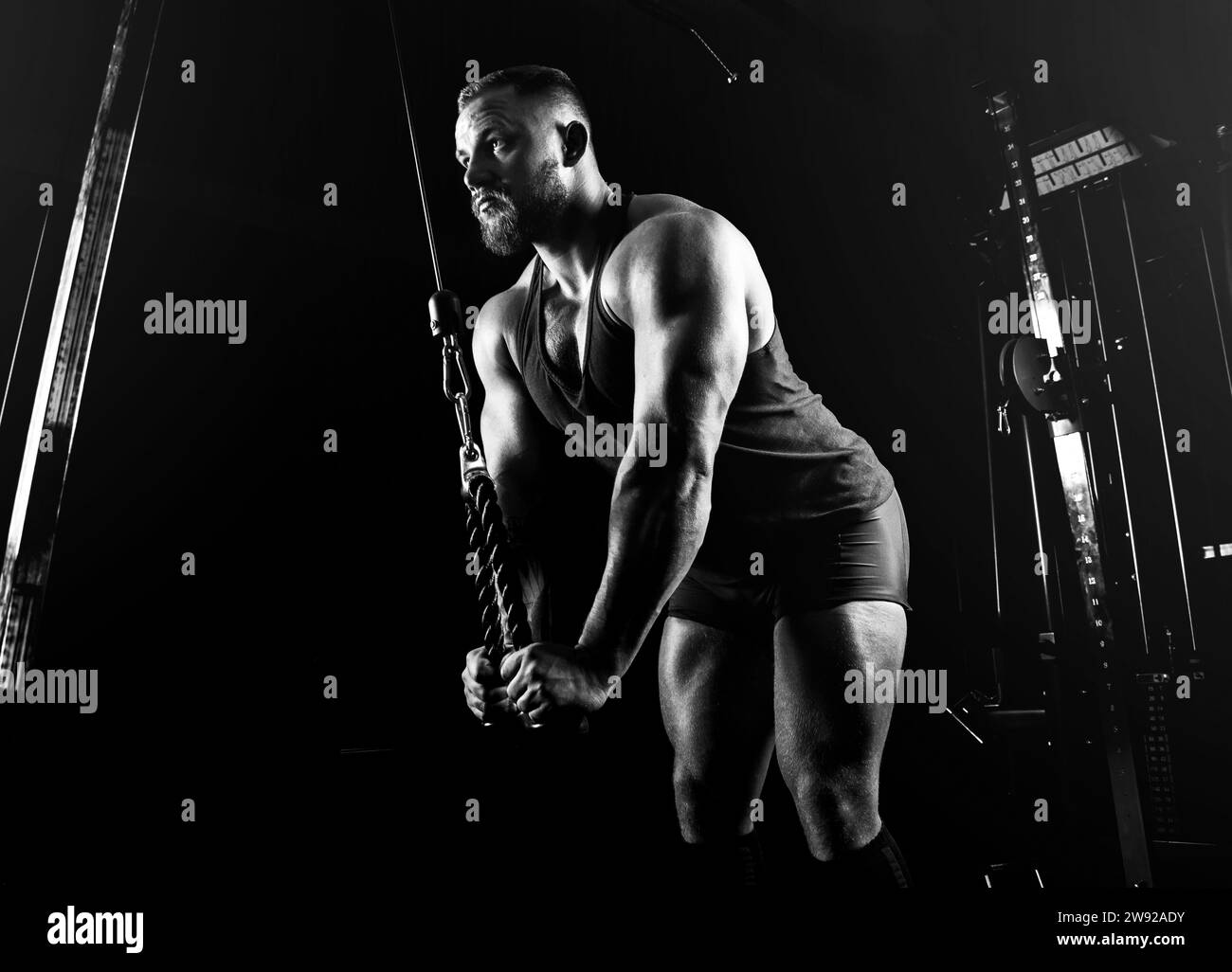 The athlete performs an exercise on the triceps on a special device ...