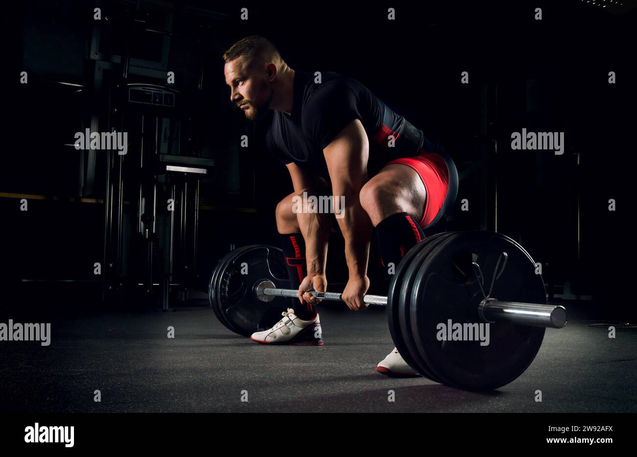 Athlete in the gym is prepared to perform an exercise called deadlift ...