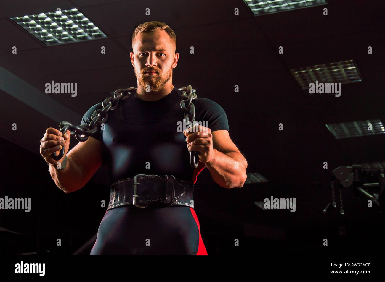 Huge weightlifter with a chain around his neck is in the gym Stock ...