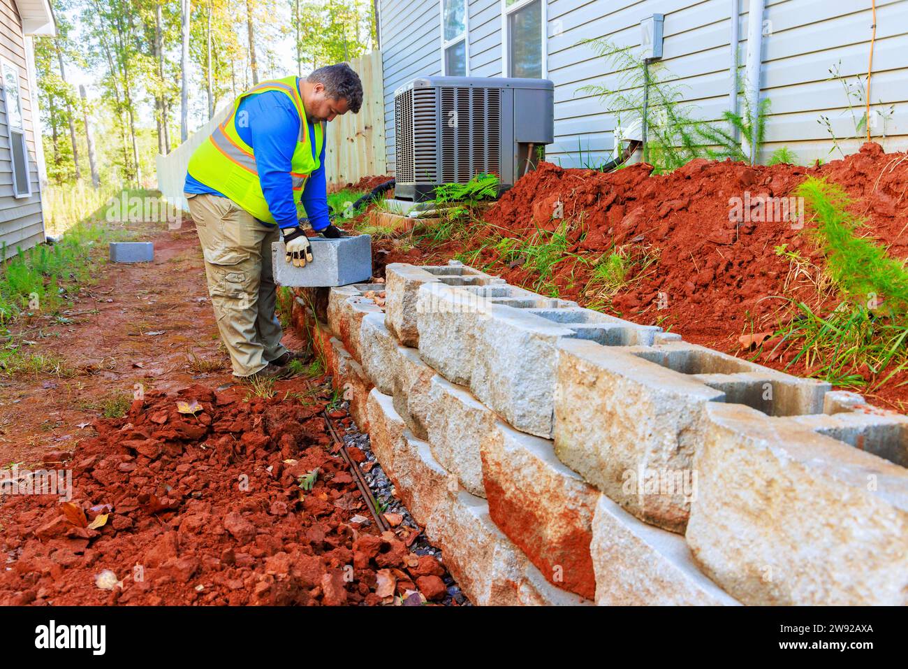 Concrete block wall is being constructed by contractor who is ...