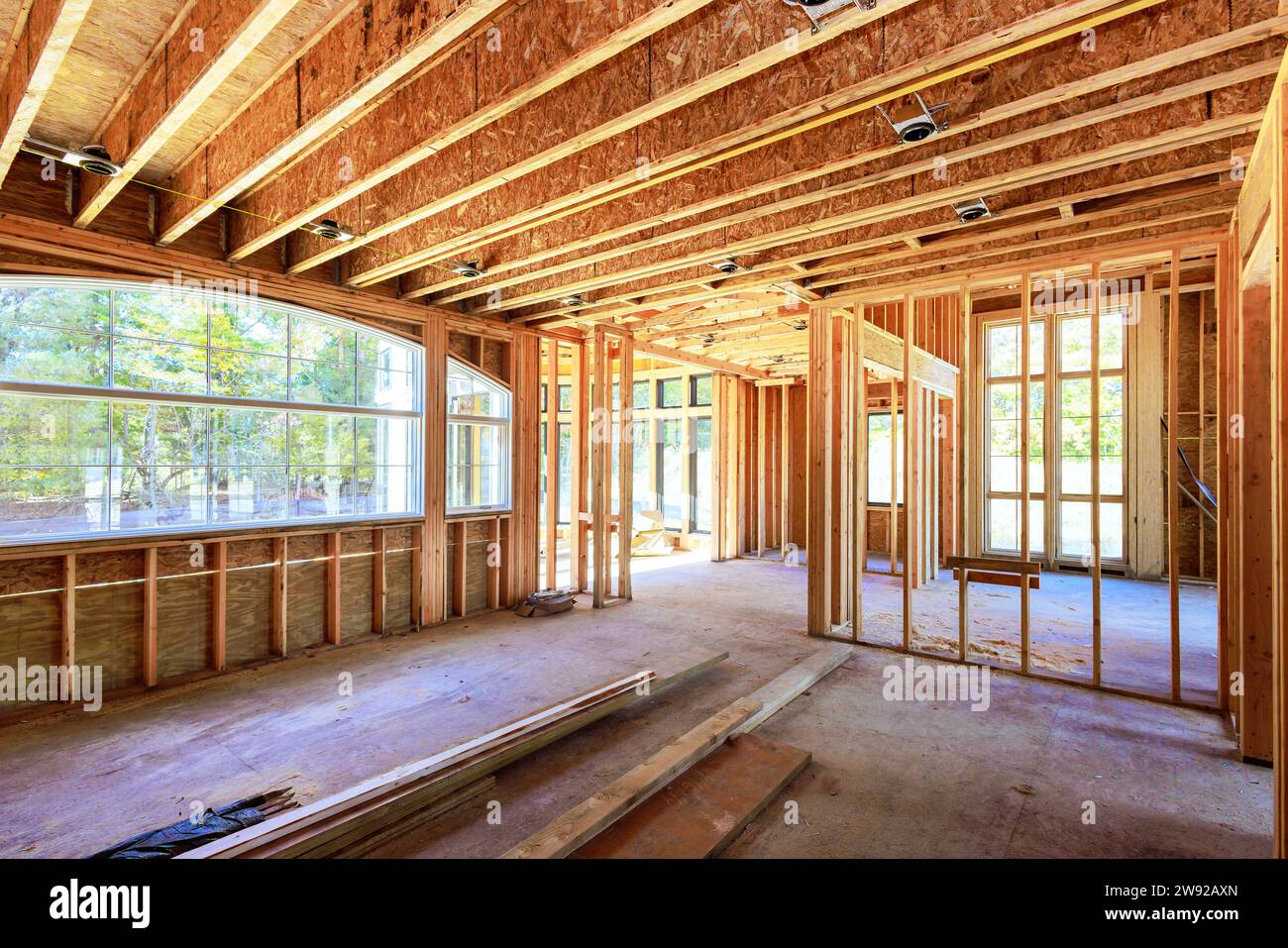 New home is being built at building area with unfinished framing beams ...