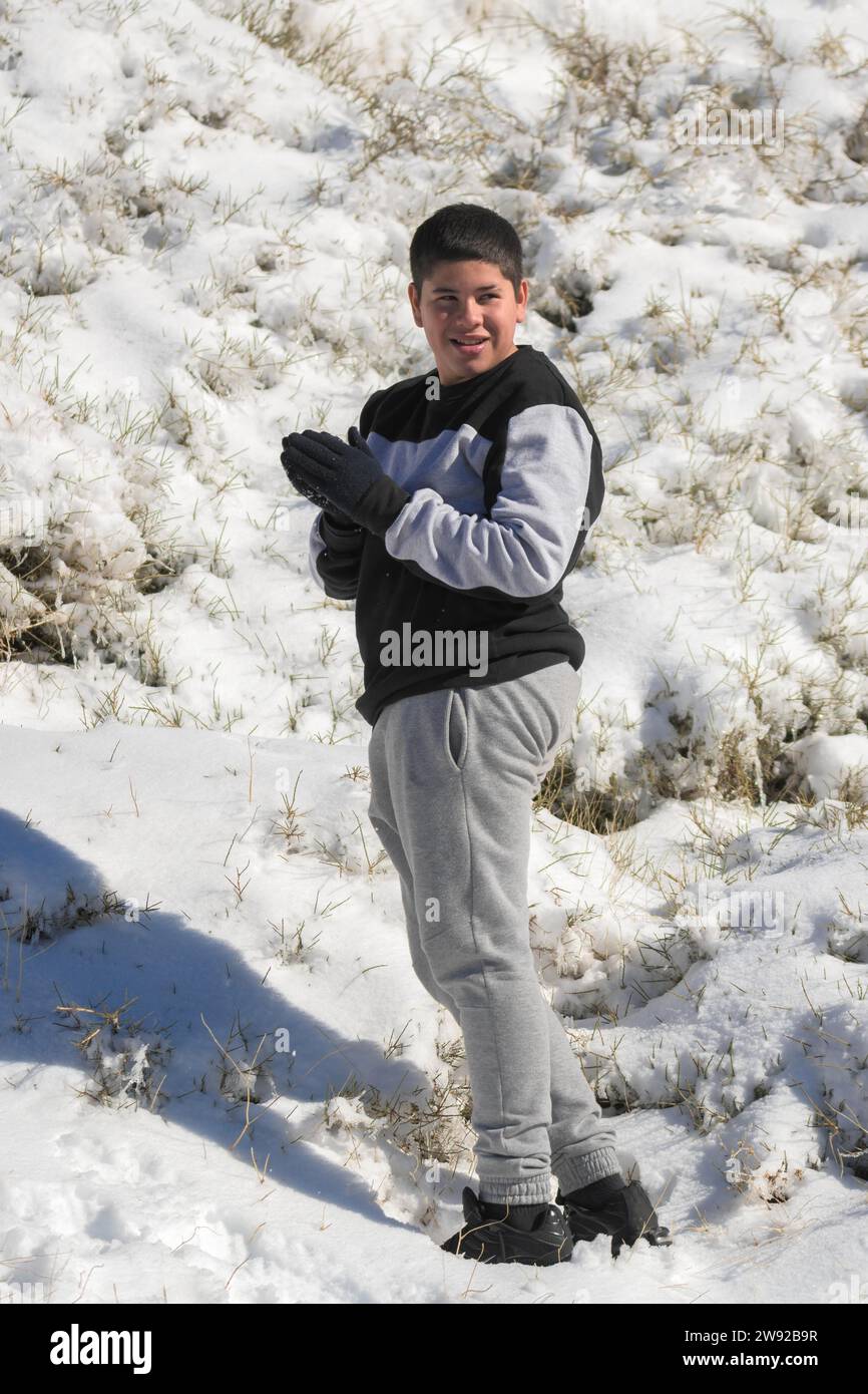 Full body portrait, young latin man in the snow, ski resort of sierra ...
