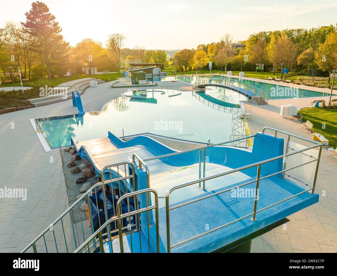 Silhouette of a swimming pool through the morning fog at sunrise in ...