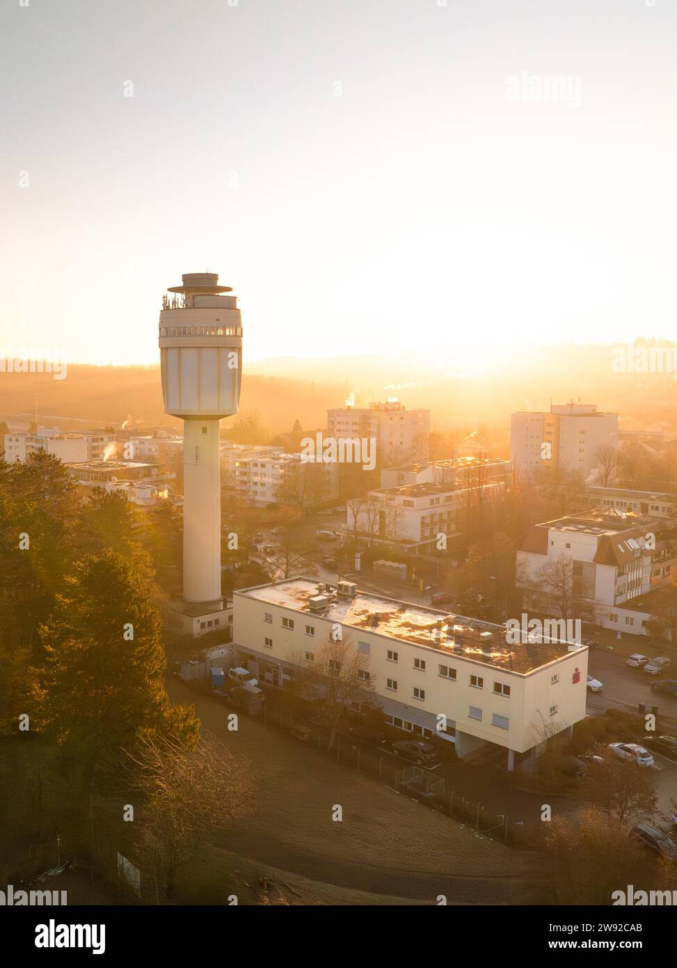 Sunrise behind a water tower, captured in an aerial photograph over the ...