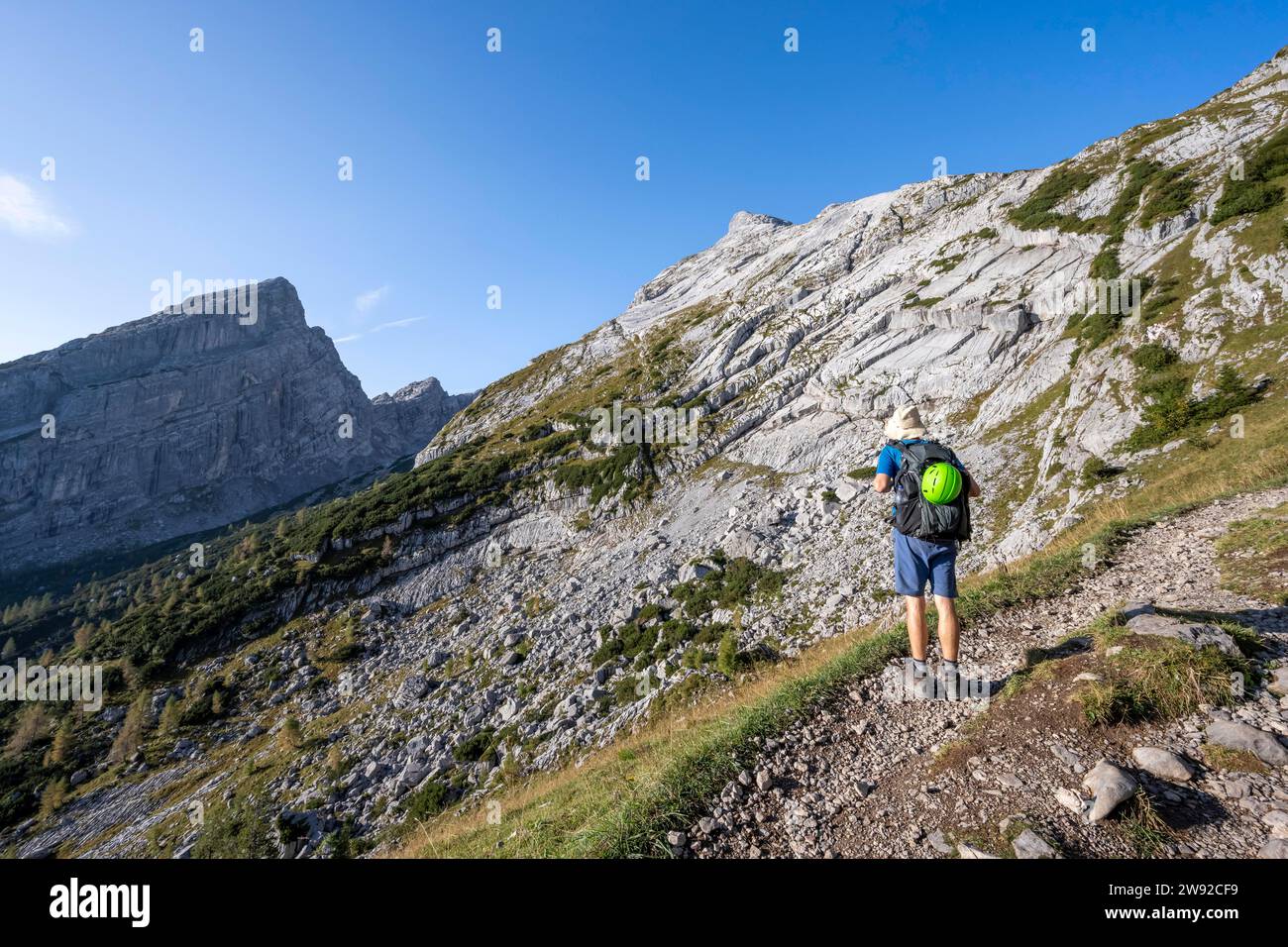 Mountaineers on a hiking trail, view of rocky mountain peaks with ...