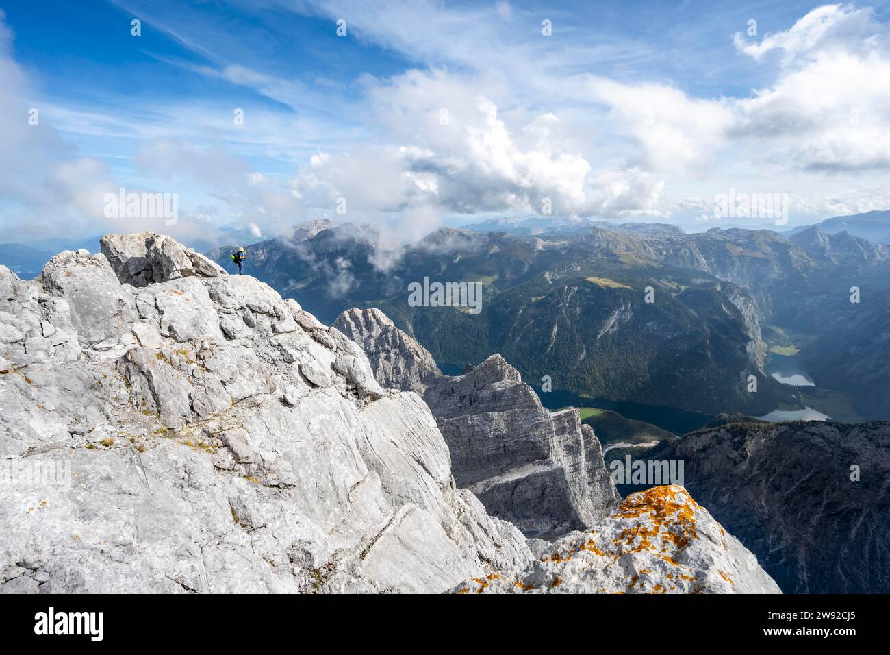 Mountaineer on the steep rocky summit of the Watzmann Mittelspitze ...