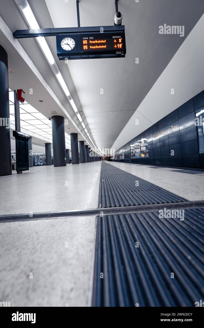 View along an underground railway platform with symmetrical structures ...