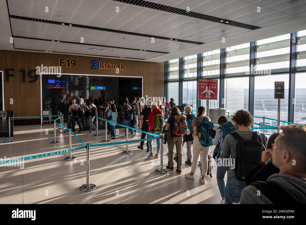 People queuing at the gate to board the aircraft, queue at G, Istanbul ...