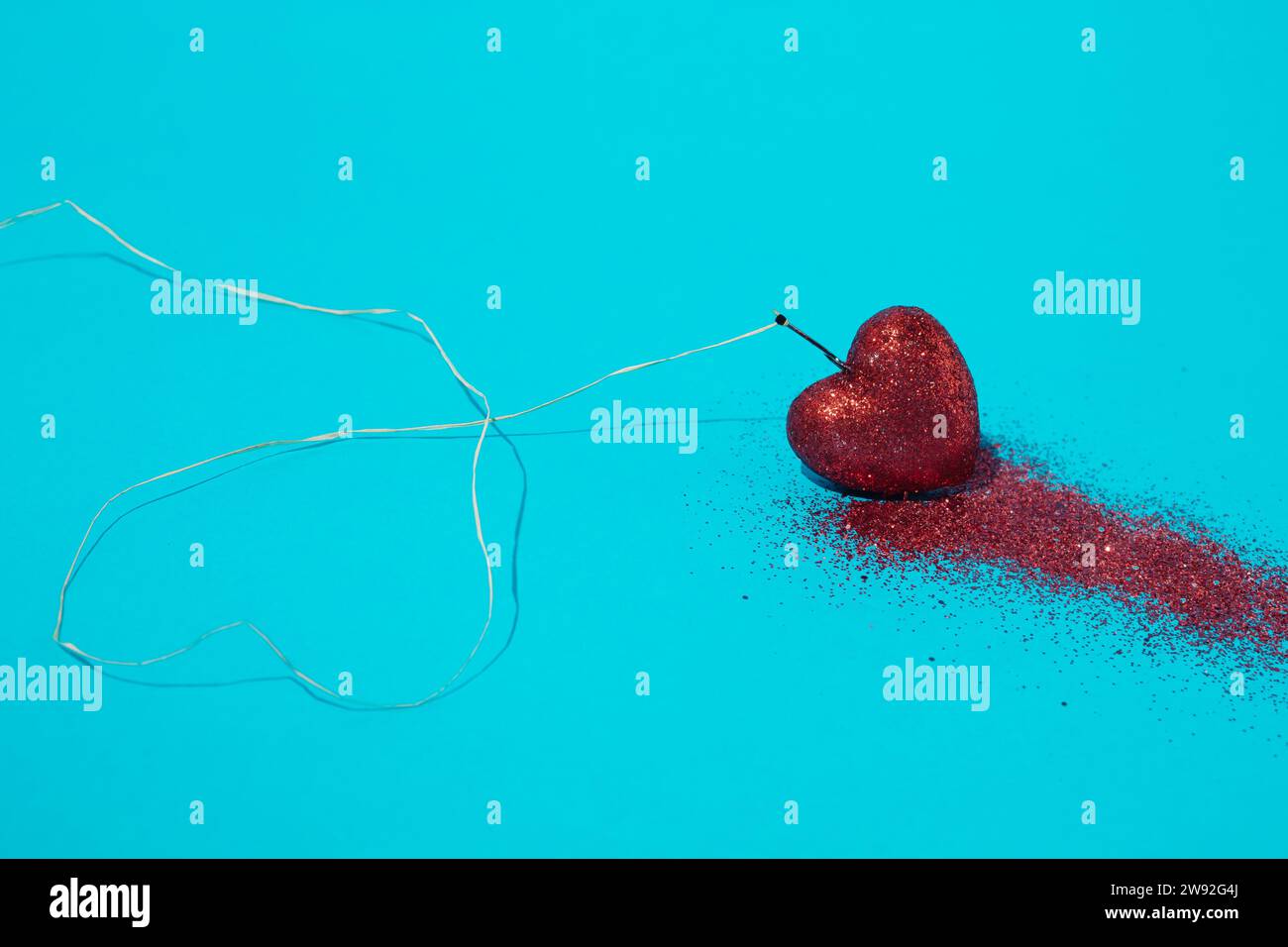 Red heart with glitter blood in a fish hook on a blue background. Love ...