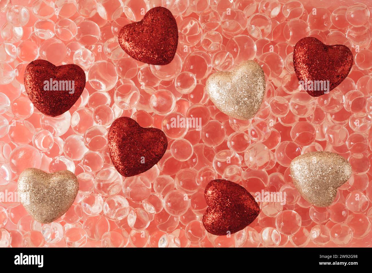 Abstract background in soft pastel peach colors with glitter hearts ...