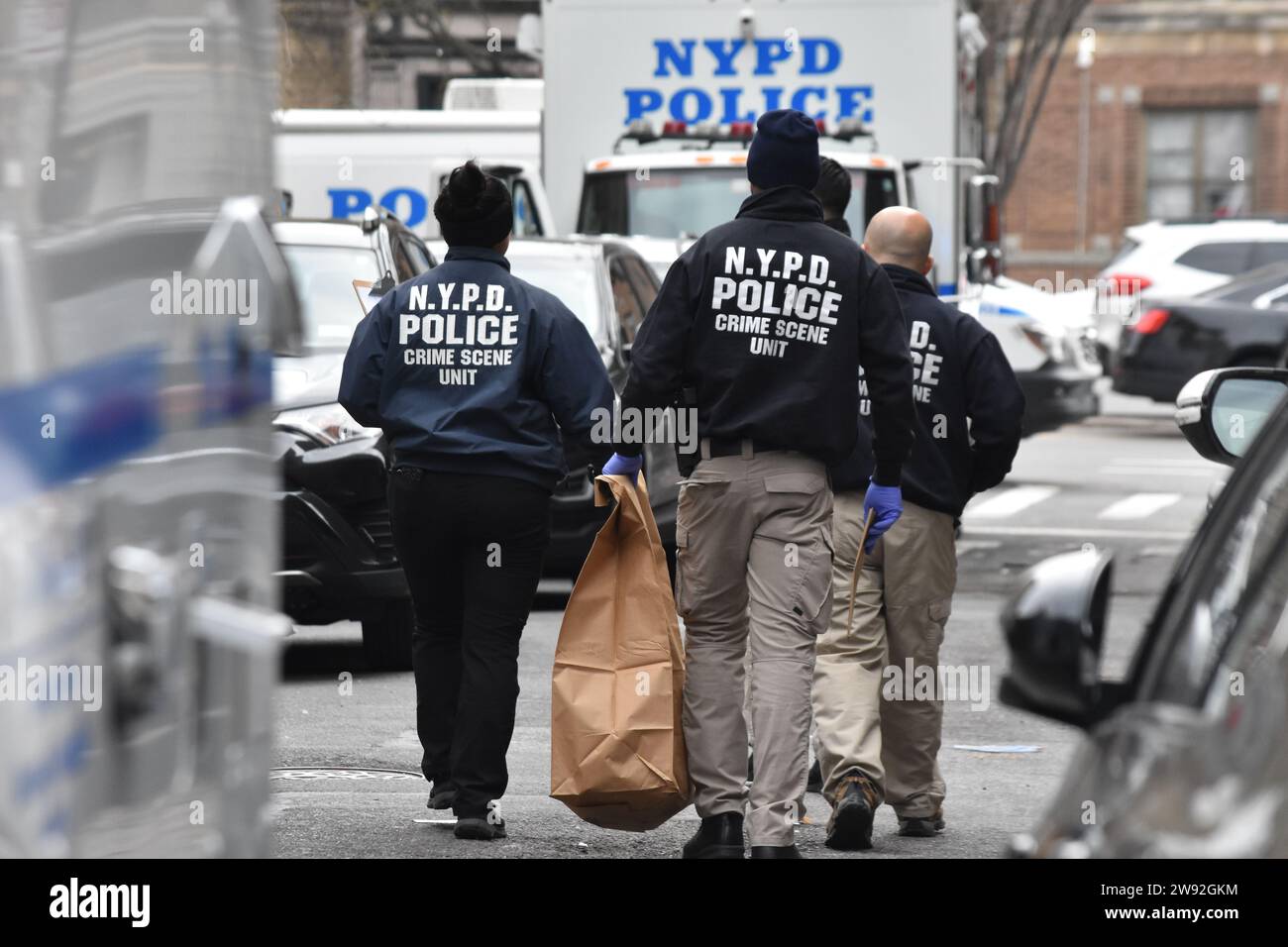 NYPD Officers from the Crime Scene Unit carry out large evidence bags ...