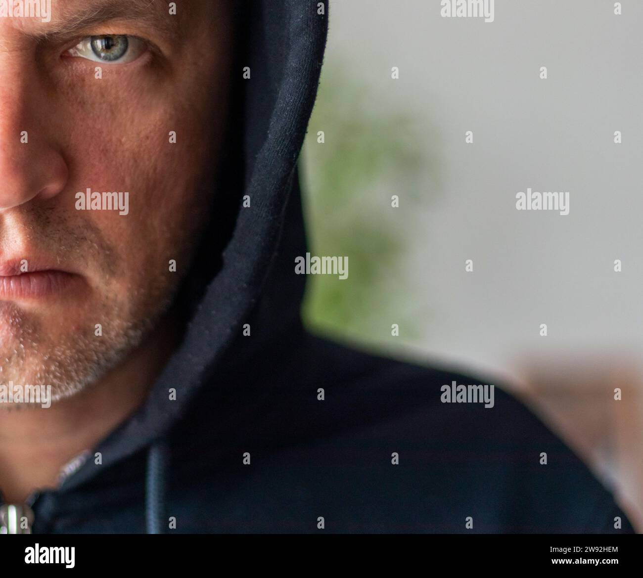 Man looked like hacker in a hood looking at the screen Stock Photo - Alamy