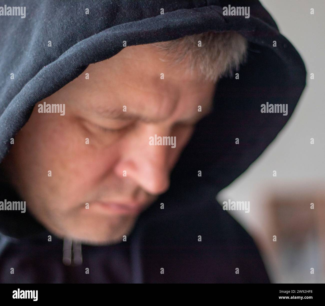 Man looked like hacker in a hood looking at the screen Stock Photo - Alamy