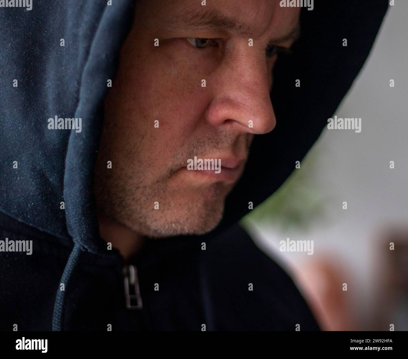 Man looked like hacker in a hood looking at the screen Stock Photo - Alamy