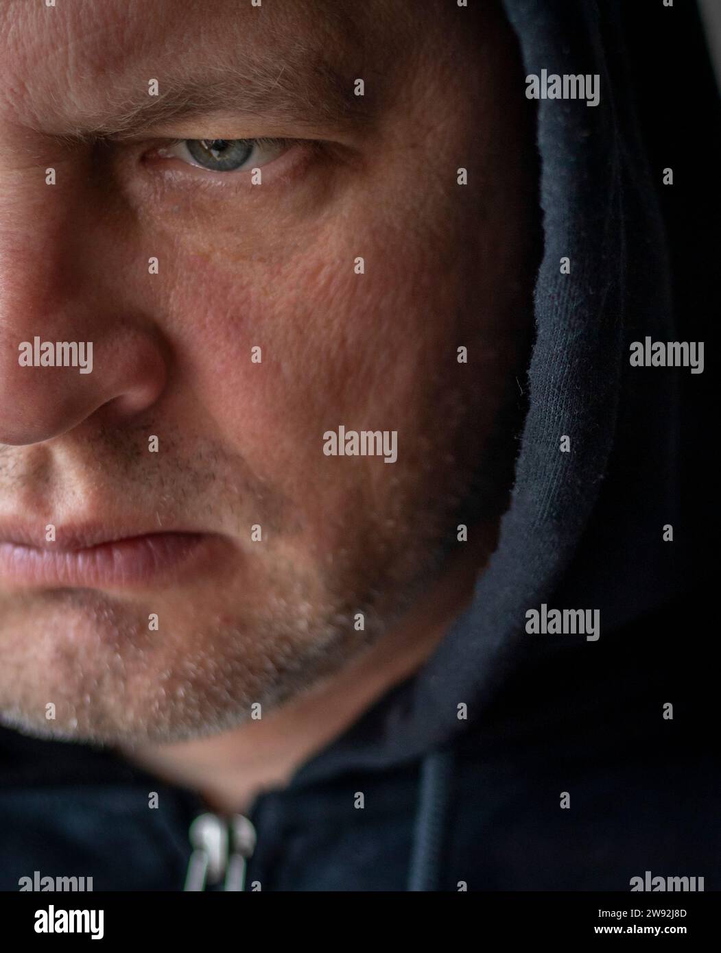 Man looked like hacker in a hood looking at the screen Stock Photo - Alamy