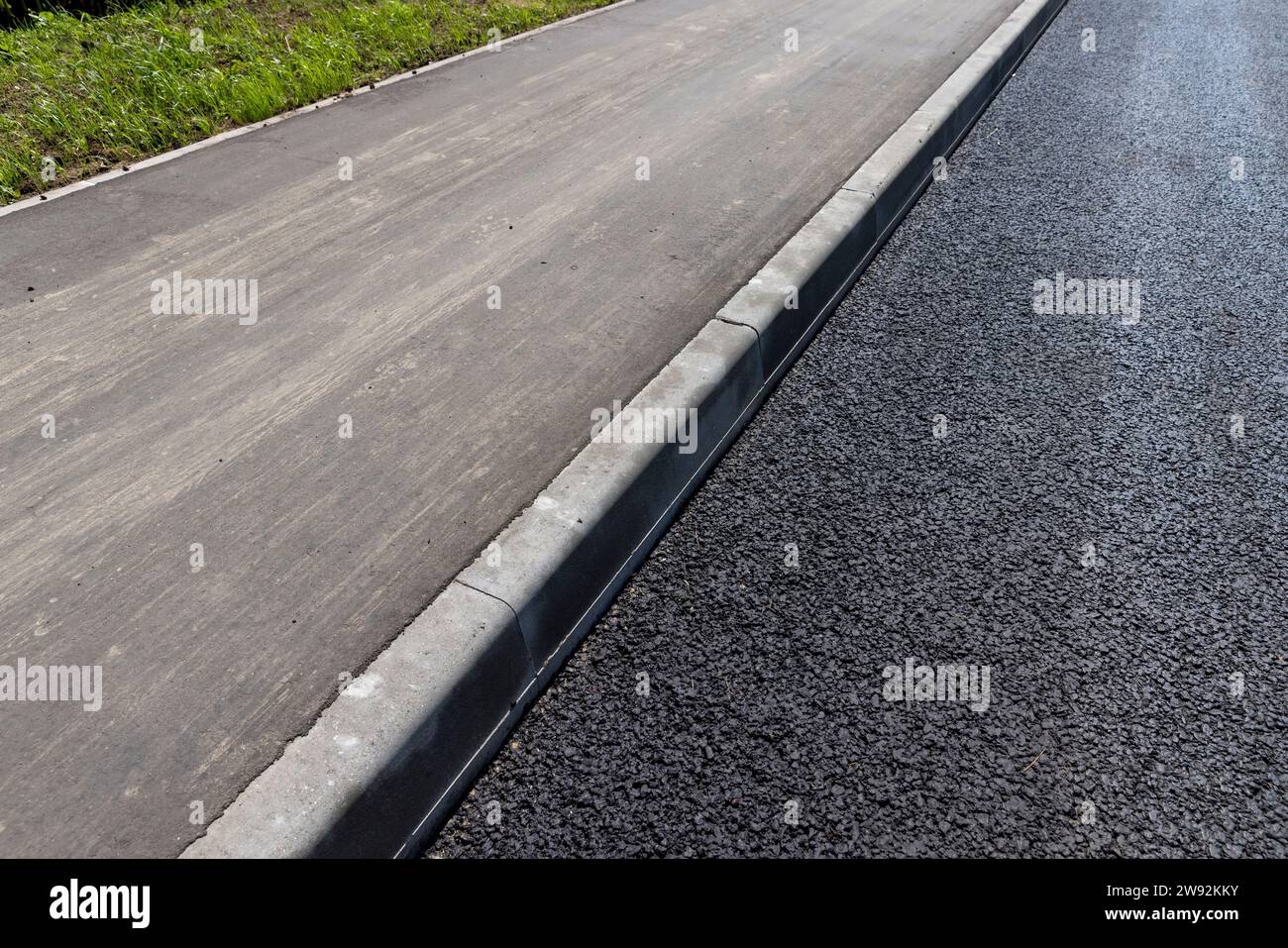 asphalting a new highway with black new asphalt, a close-up of a part ...