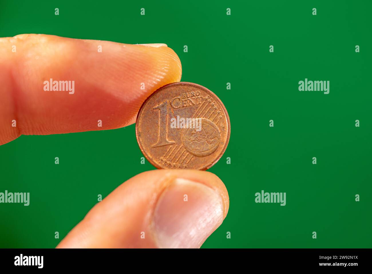 1 euro cent coin face held between thumb and index finger Stock Photo ...