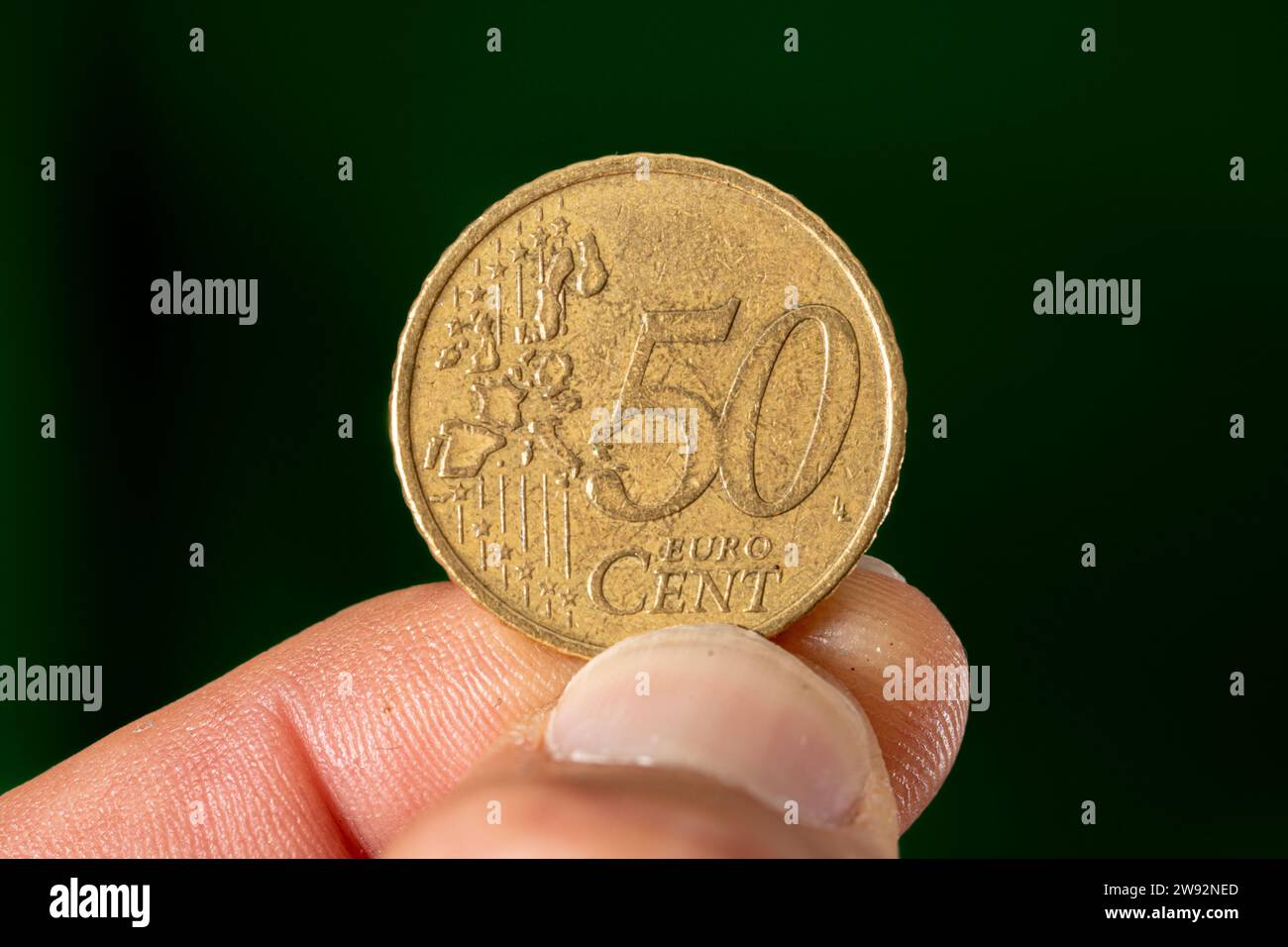 50 euro cent coin face held between thumb and index finger Stock Photo ...