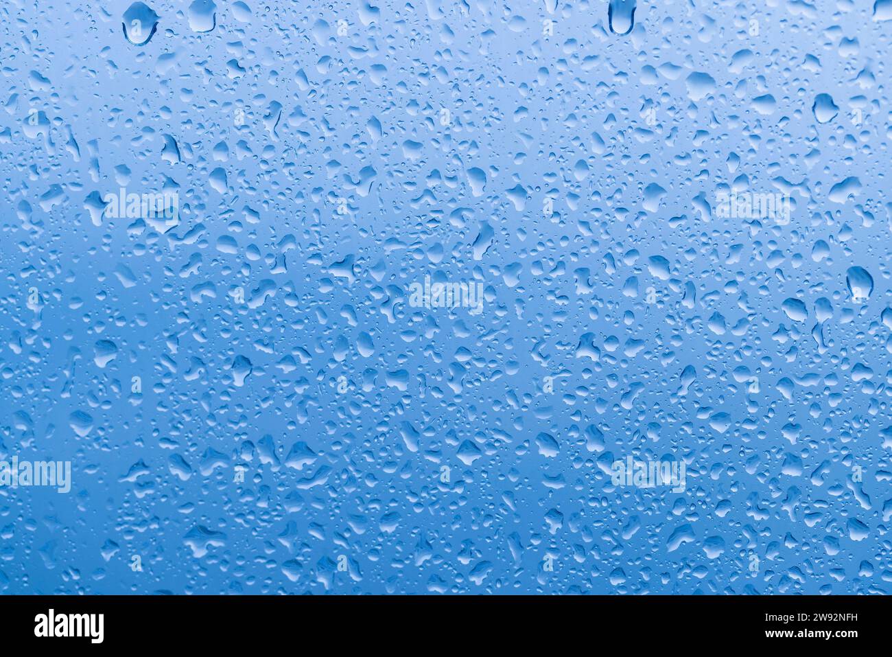 water drops on the glass during rain, wet transparent glass with water ...