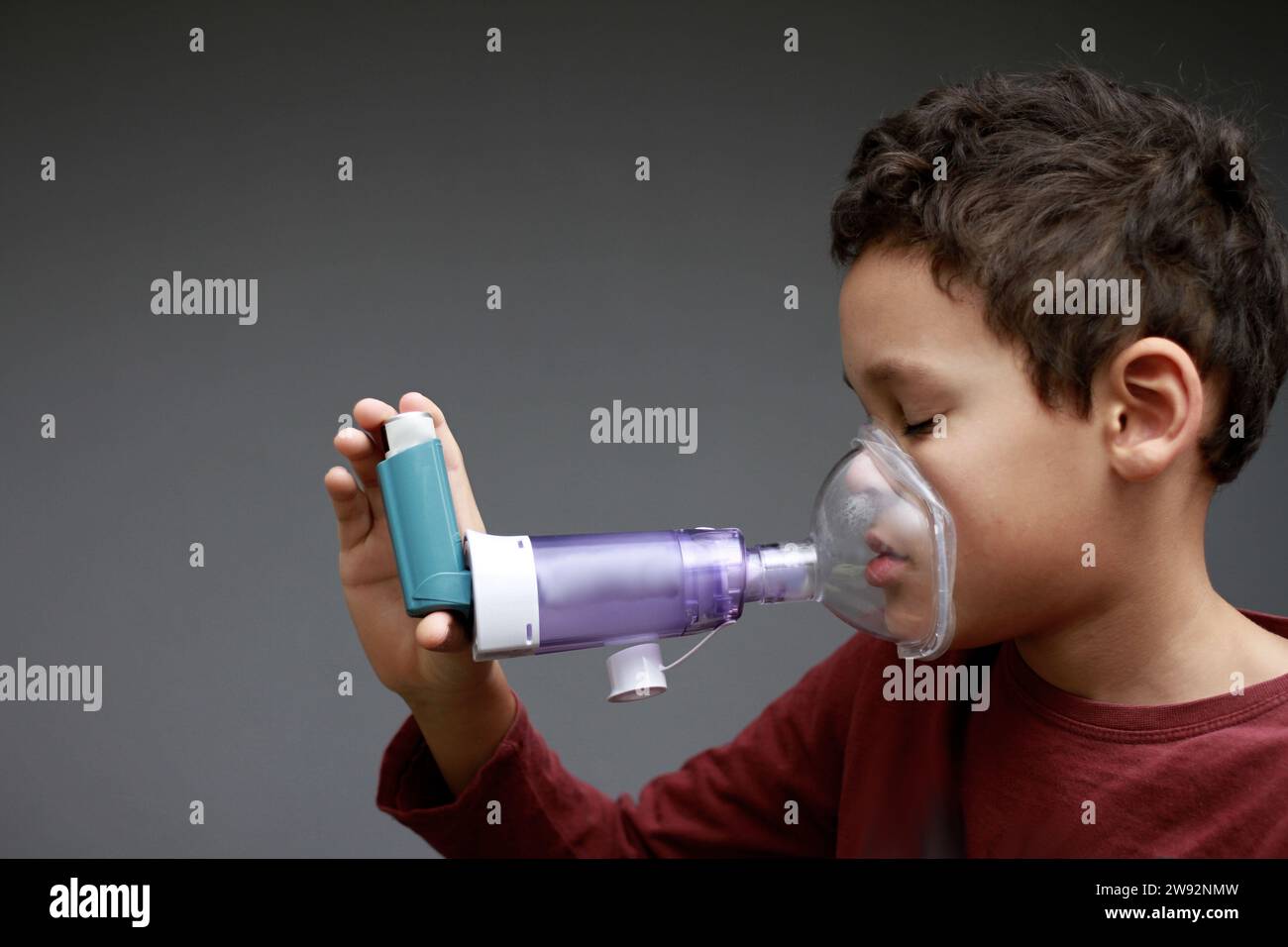 child with flu and inhaler respiratory puff on grey background with ...