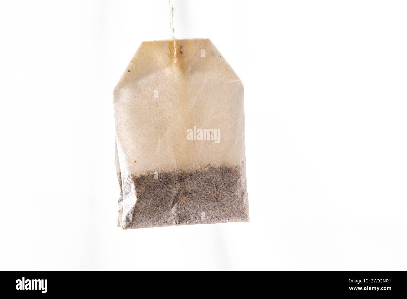 white translucent tea or infusion sachet on white color background ...